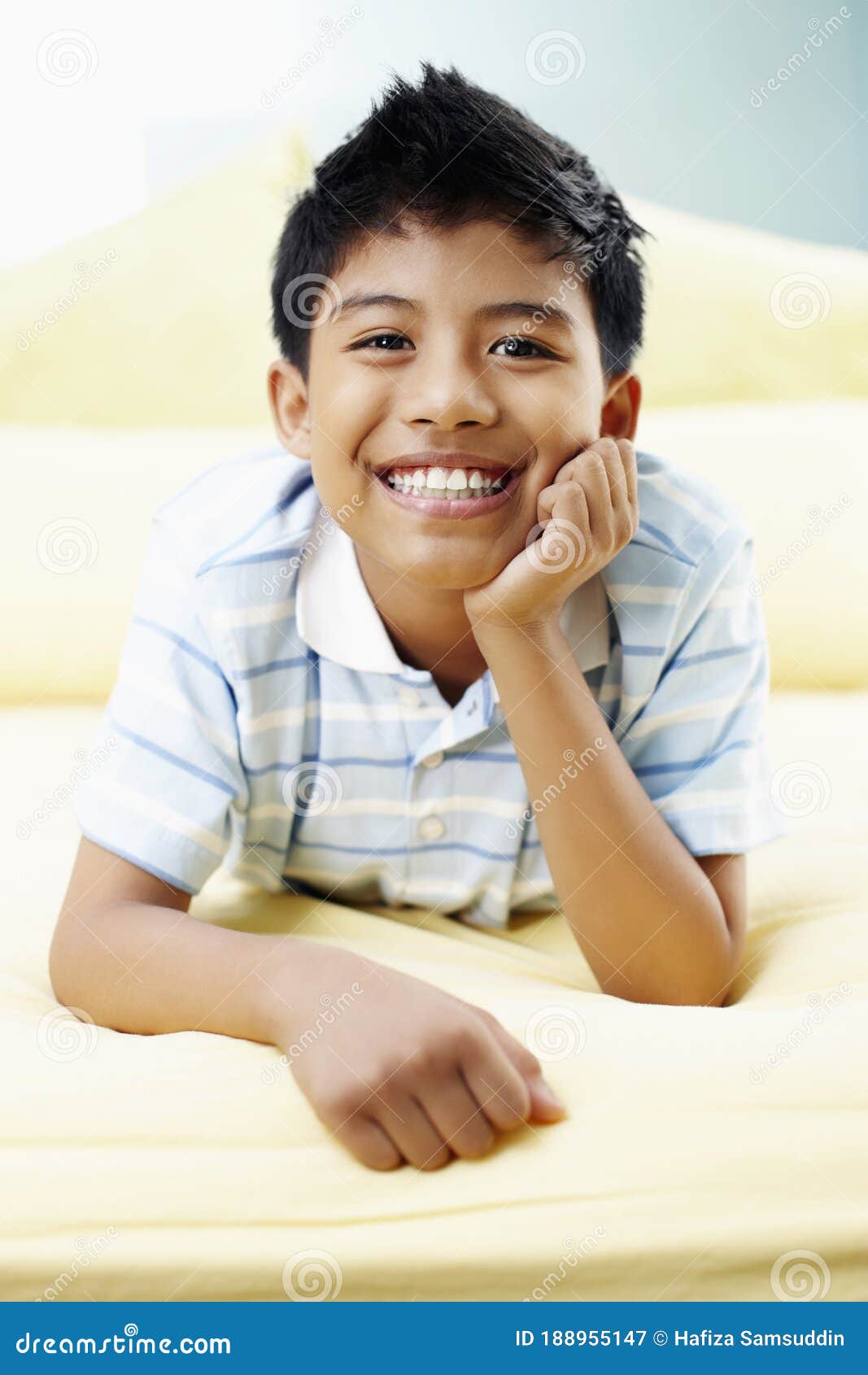 Boy Lying Forward in Bed Smiling. Conceptual Image Stock Image - Image ...