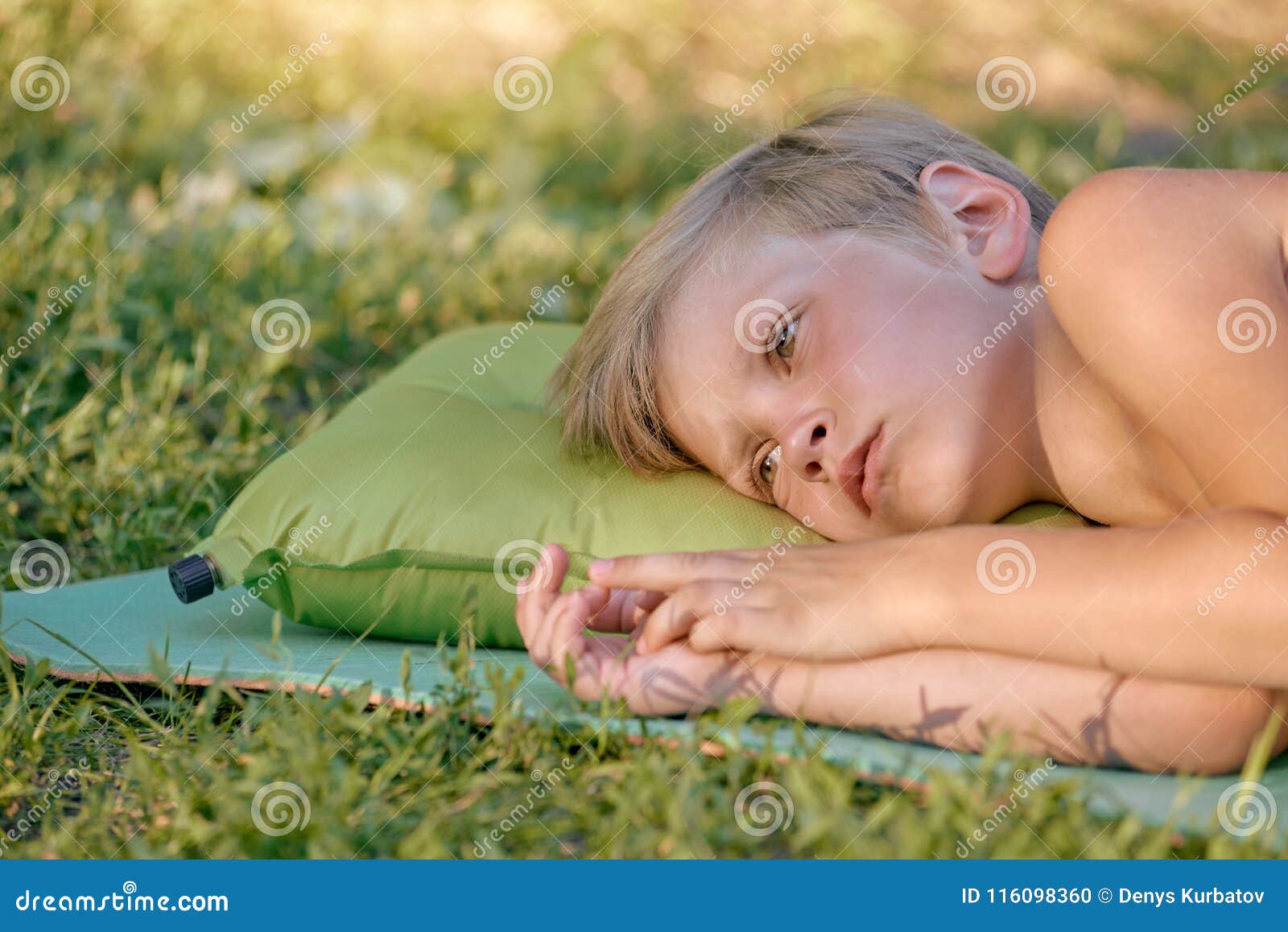 Boy lying on grass stock photo. Image of active, leisure - 116098360