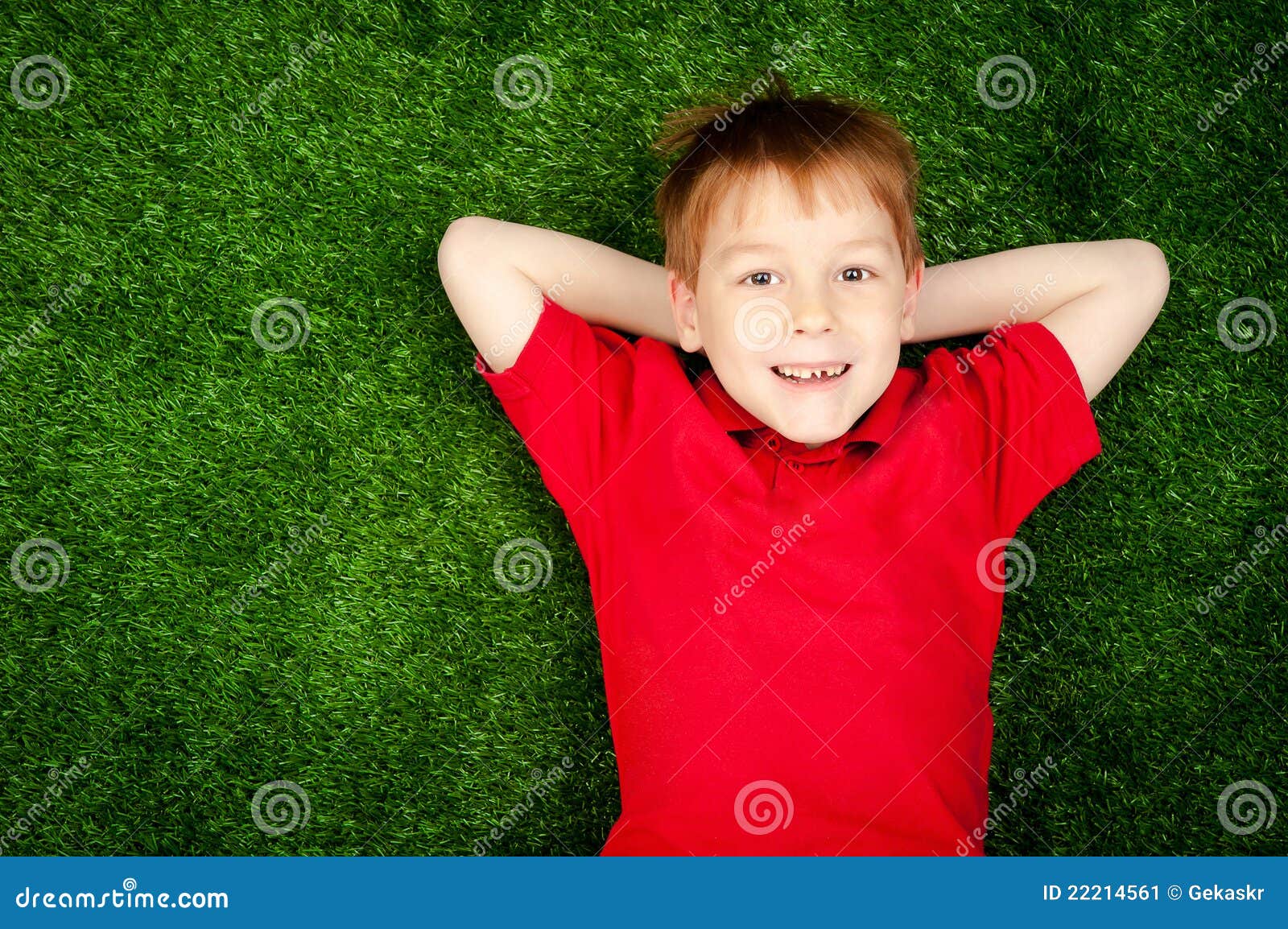Boy lying on a green lawn stock image. Image of young - 22214561