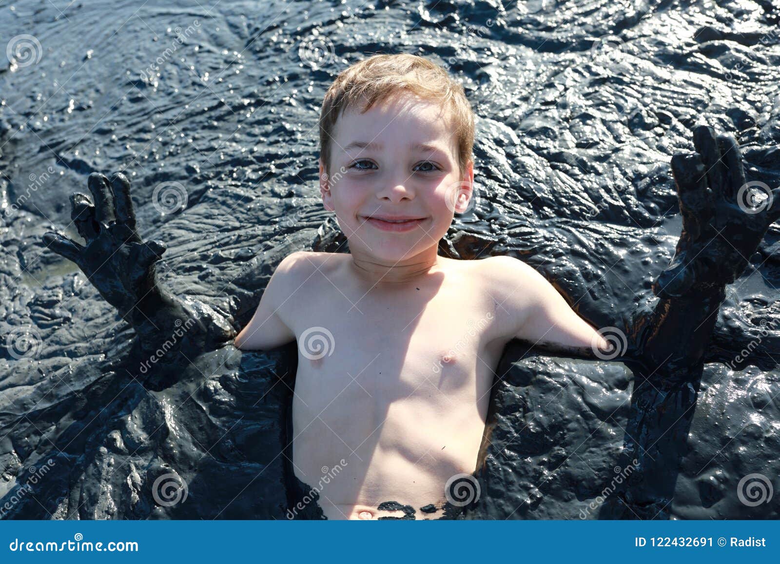 Boy lying in healing mud stock image. Image of life - 122432691