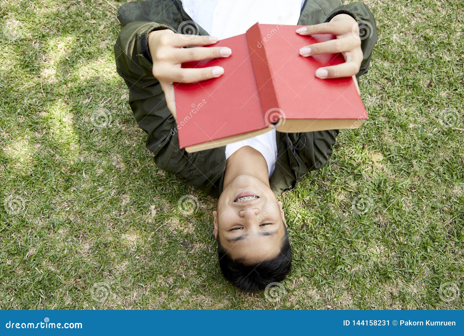 Boy Lying Reading Red Book on Green Grass Stock Image - Image of relax ...