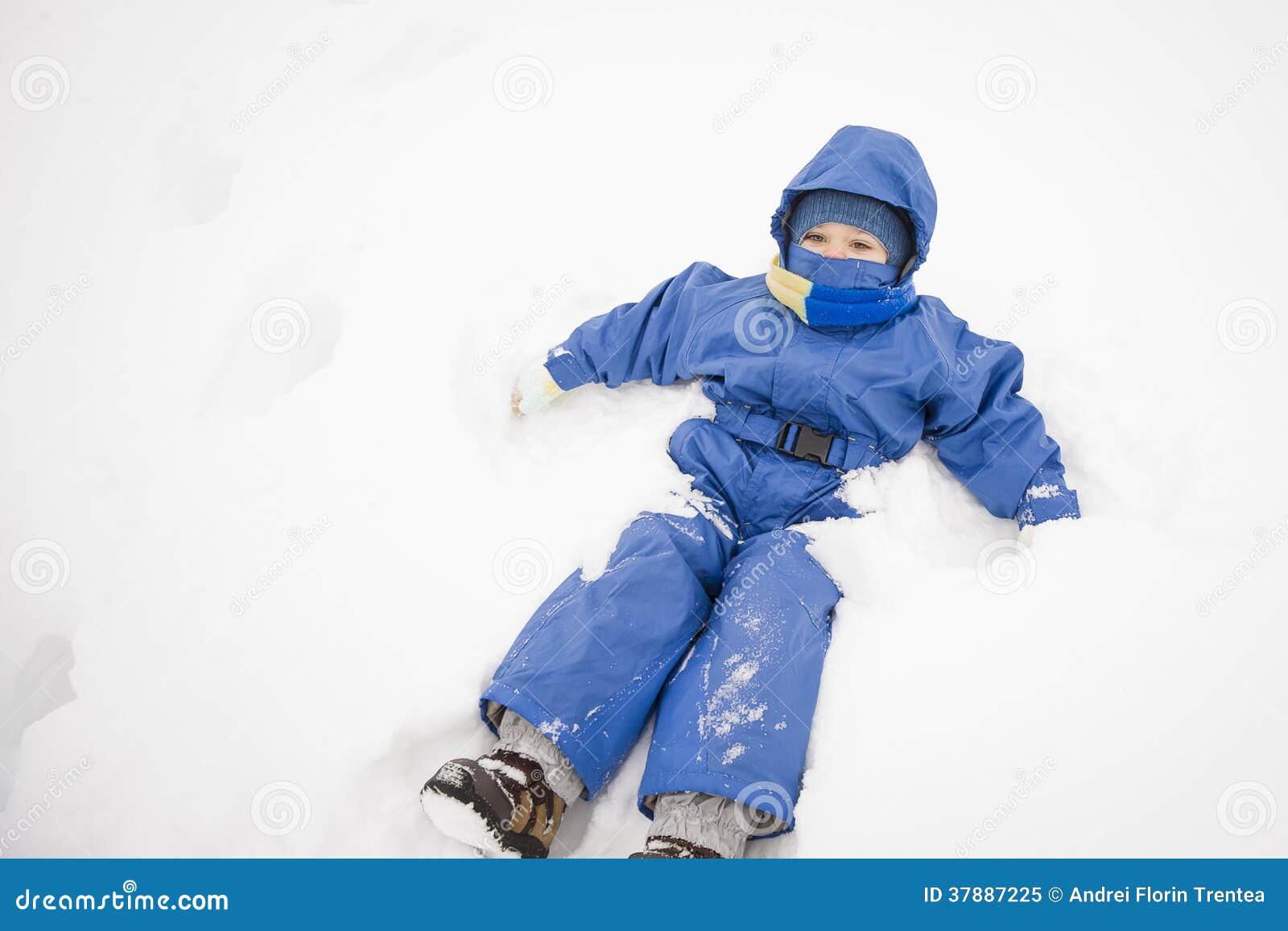 Boy lying in the snow stock image. Image of waterproof - 37887225