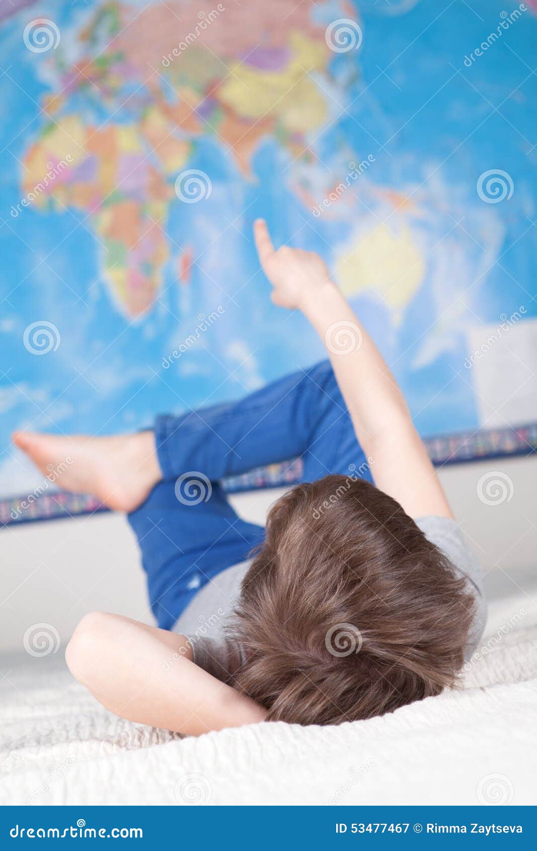 Boy Lying on Sofa and Studying Map of World Stock Image - Image of ...