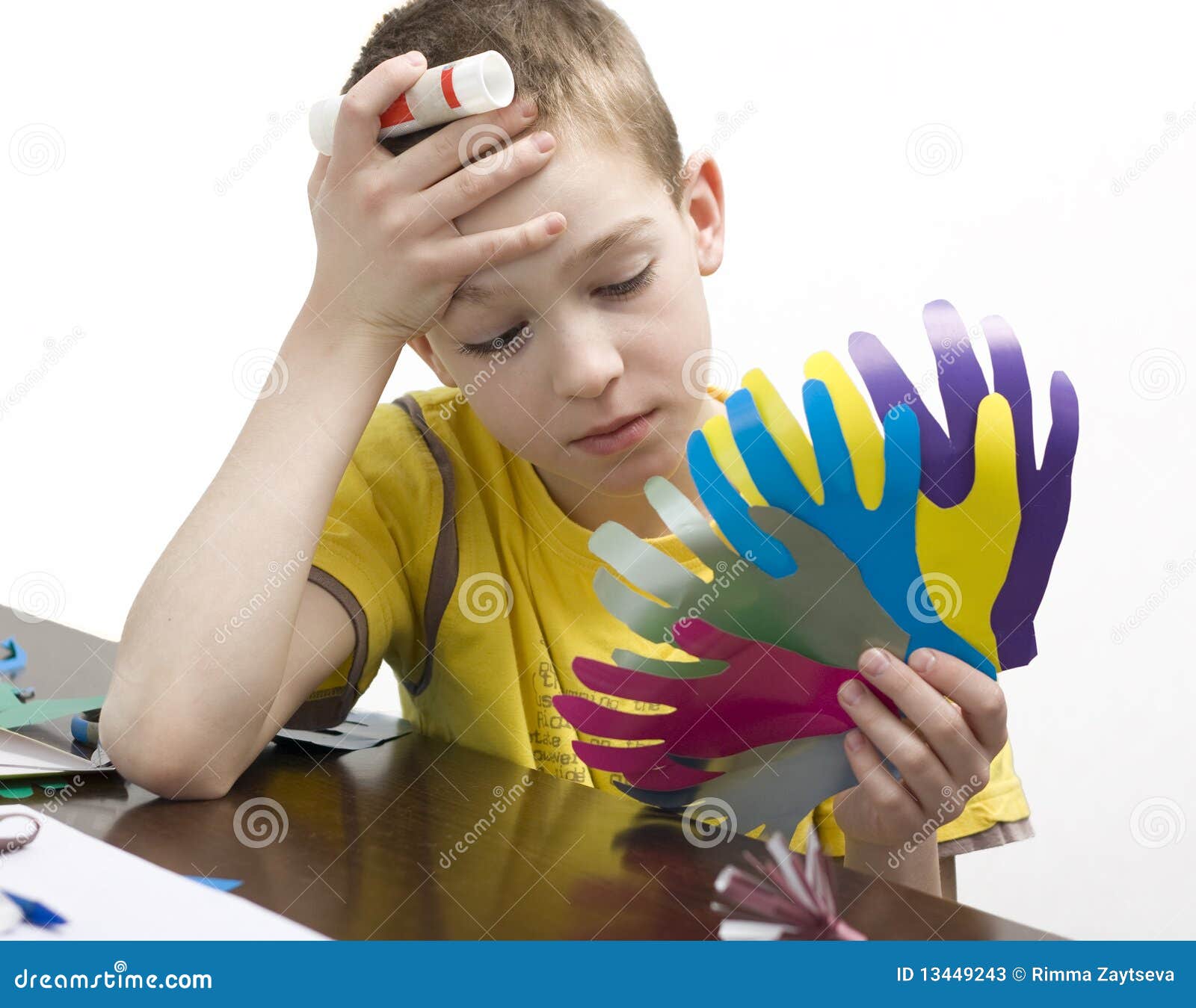 The boy makes crafts. stock image. Image of serious, think - 13449243