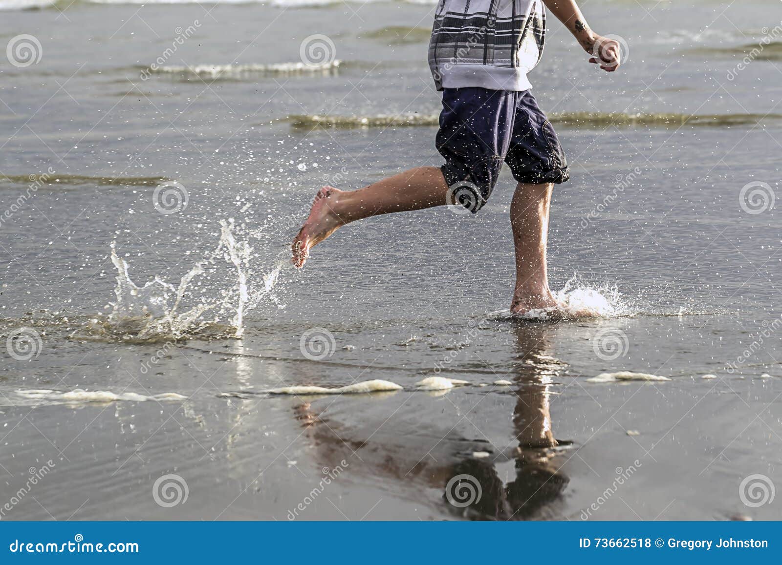 Boy makes splash at beach. stock photo. Image of washington - 73662518