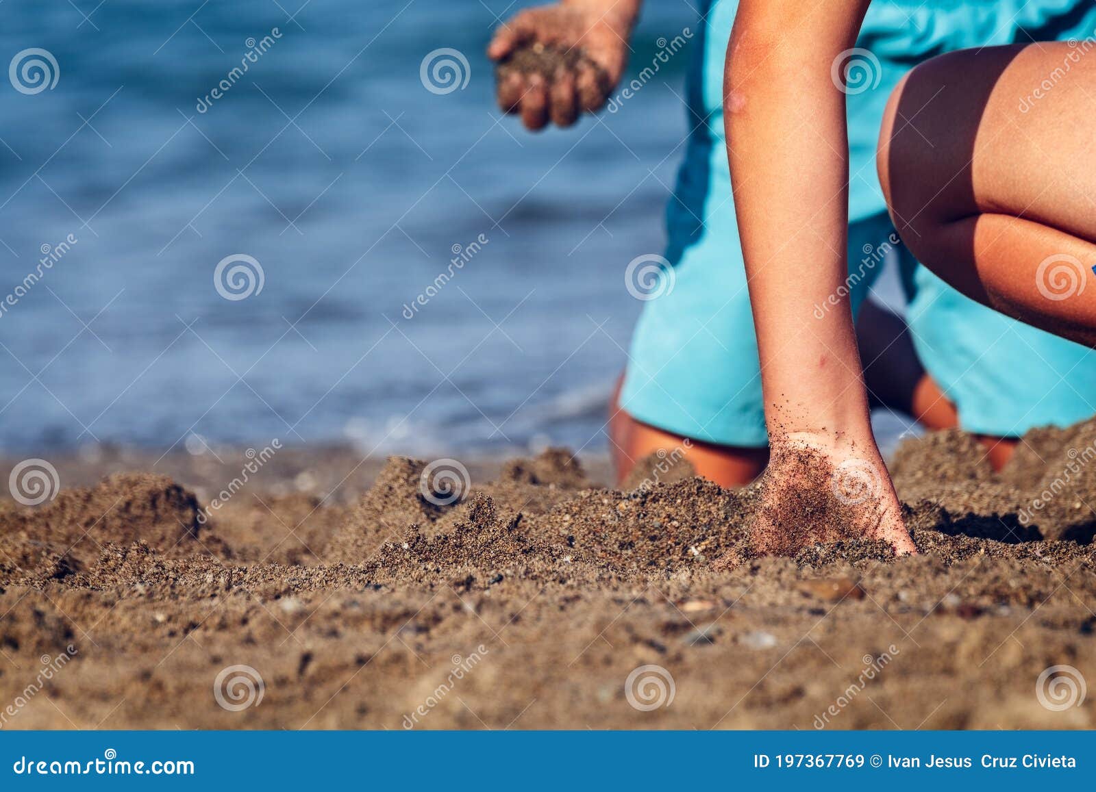 Boy Making Castles in the Sand of the Shore of the Beach. Summer Stock ...
