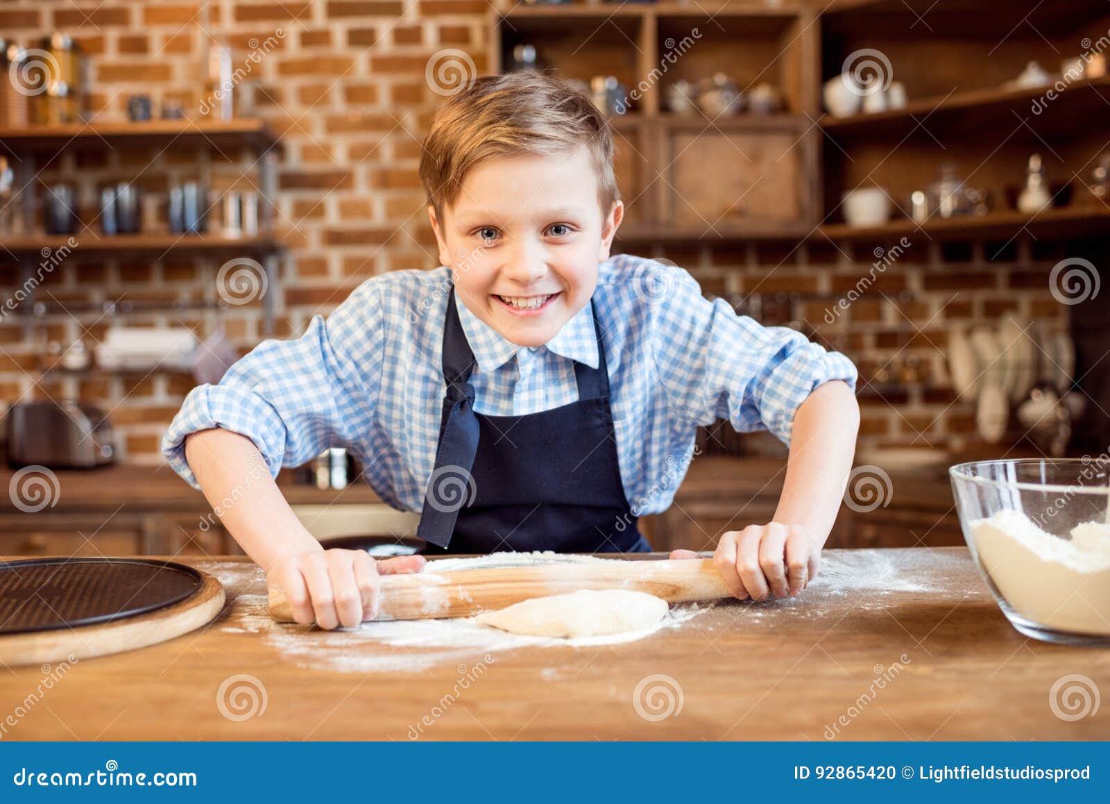 Boy Making Pizza Dough on Wooden Tabletop in Kitchen Stock Photo ...