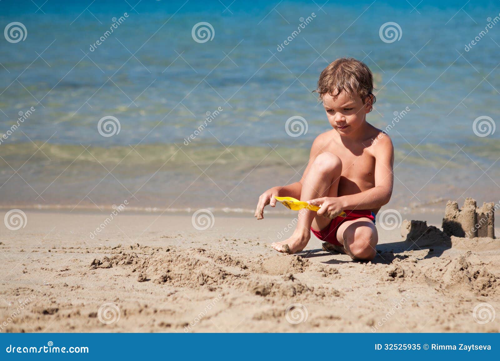 Boy Making Sand Castle on Beach Stock Image - Image of shore, sand ...