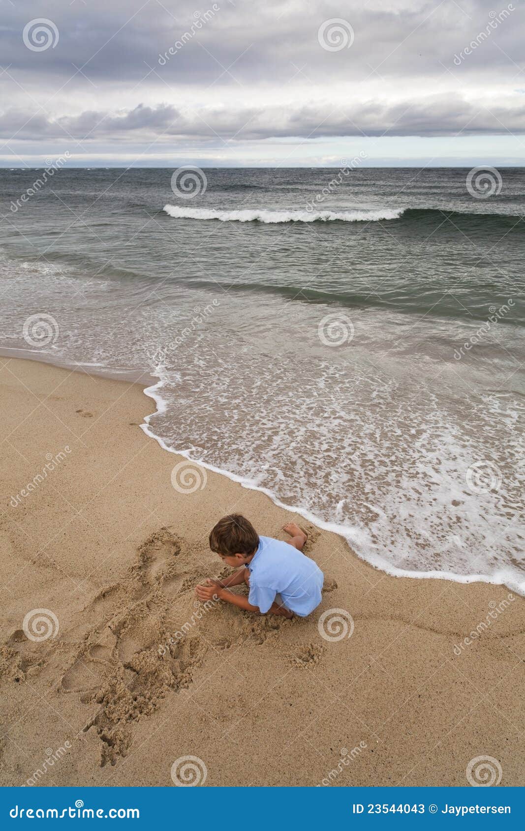 Boy making a sandcastle stock image. Image of seashore - 23544043