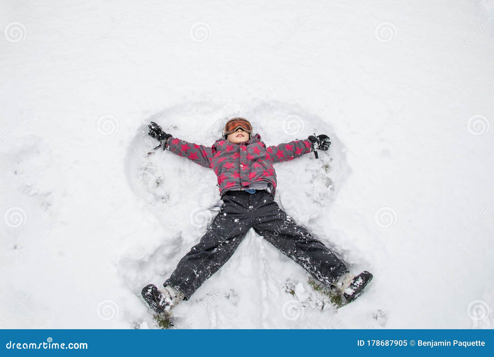 Boy Making a Snow Angel in the Snow Stock Image - Image of white ...