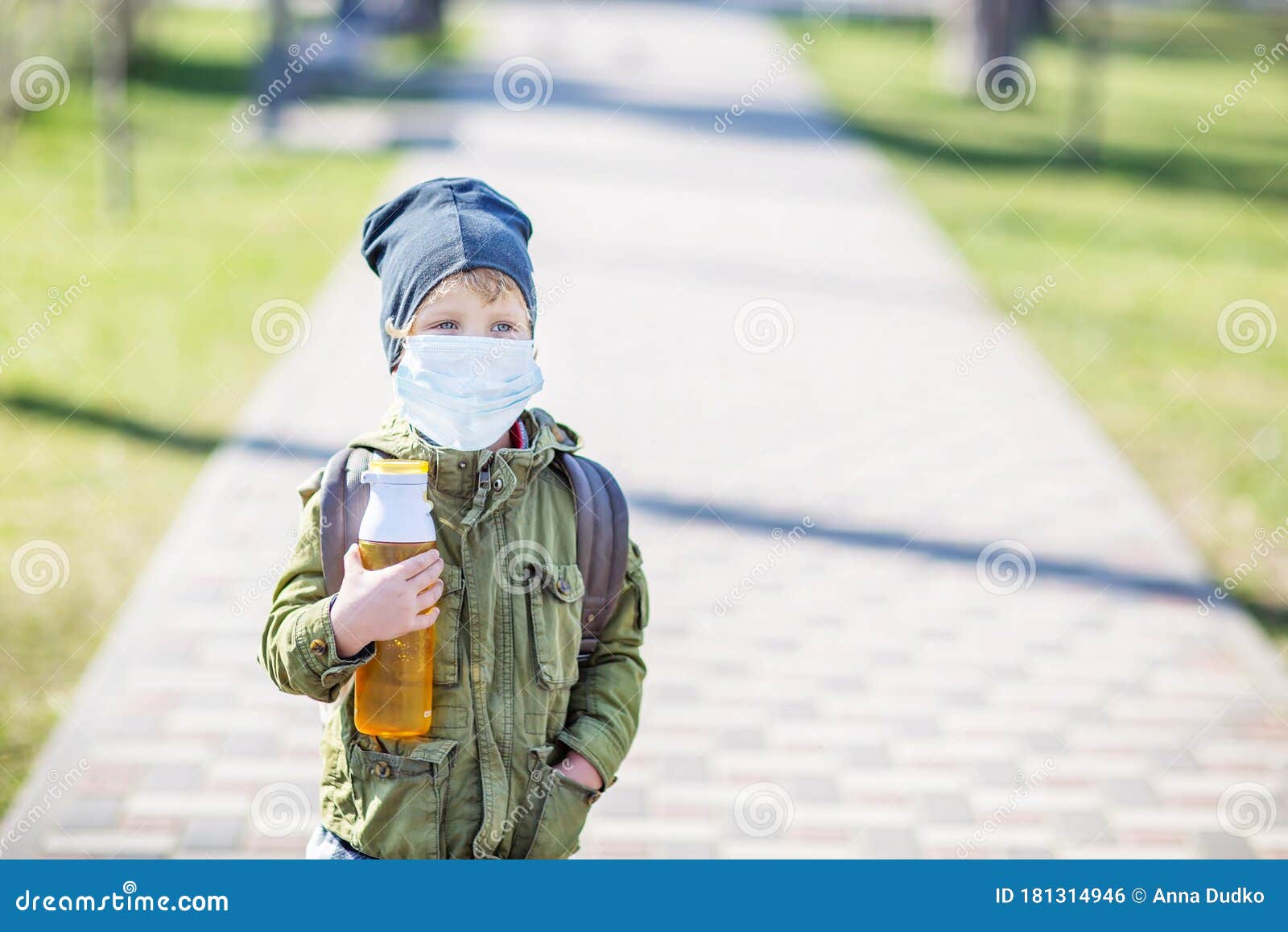 A Boy in Mask Holds a Bottle of Water in Hand Stock Photo - Image of ...