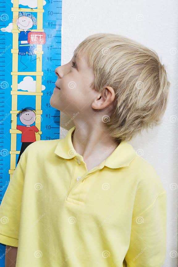 Boy Measuring Height in Classroom Stock Image - Image of educational ...