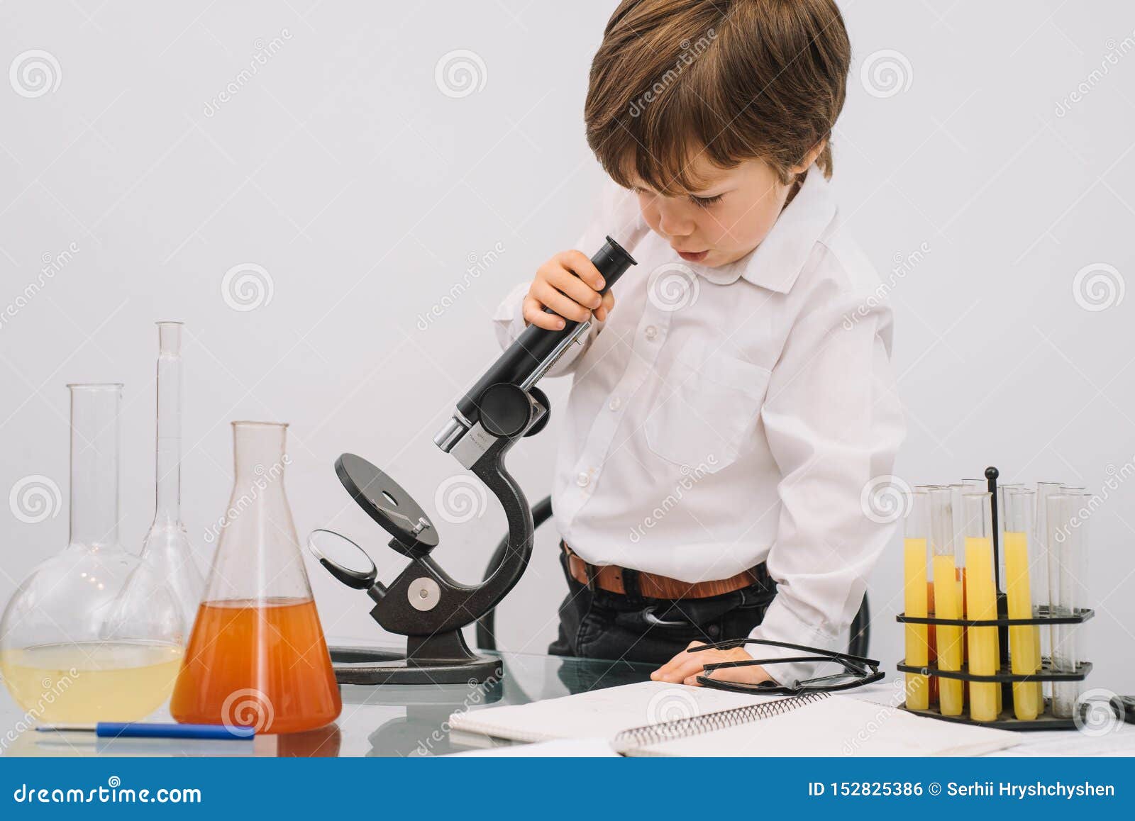 The Boy With A Microscope And Various Colorful Flasks On A White ...