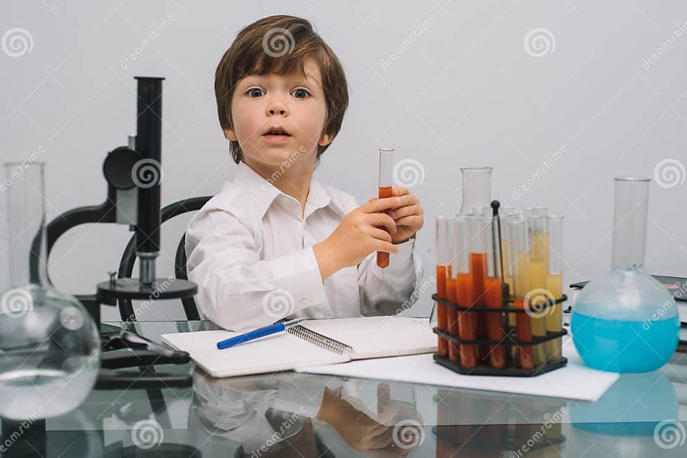 The Boy with a Microscope and Various Colorful Flasks on a White ...