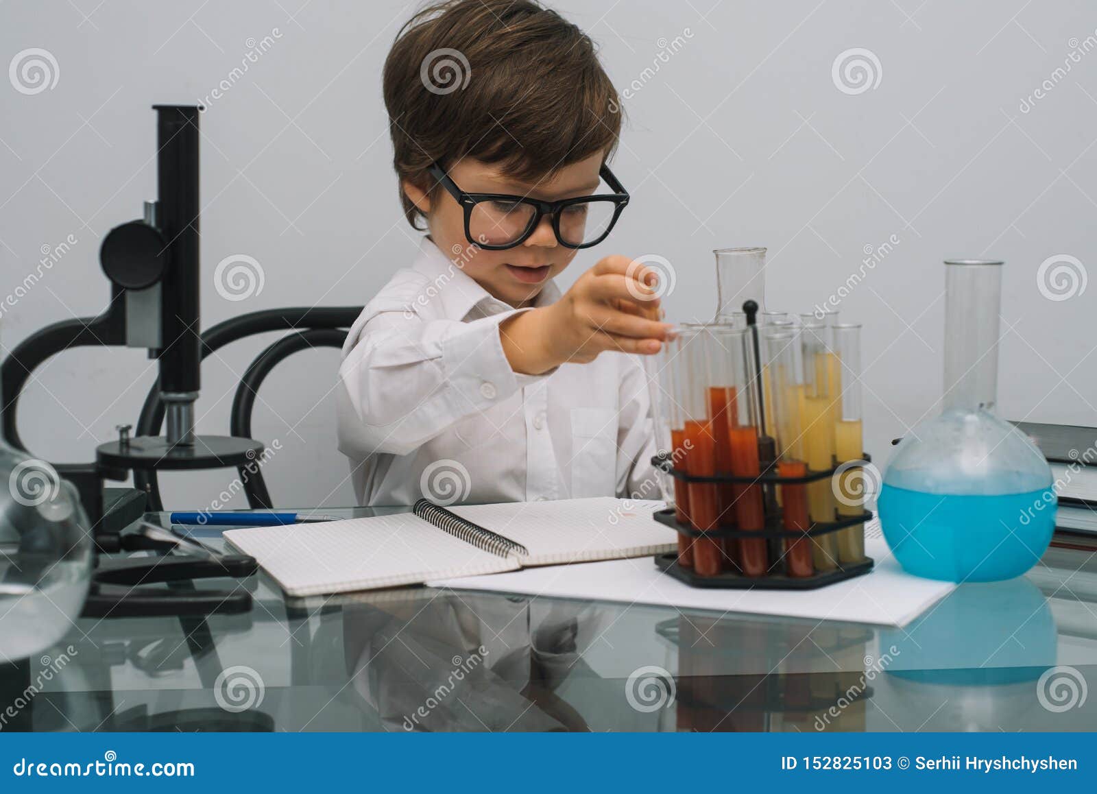 The Boy With A Microscope And Various Colorful Flasks On A White ...