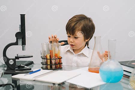 The Boy with a Microscope and Various Colorful Flasks on a White ...