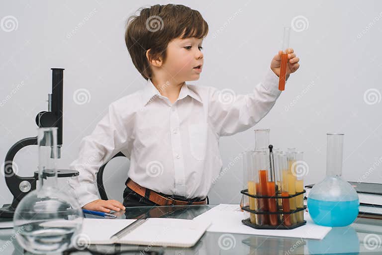 The Boy with a Microscope and Various Colorful Flasks on a White ...
