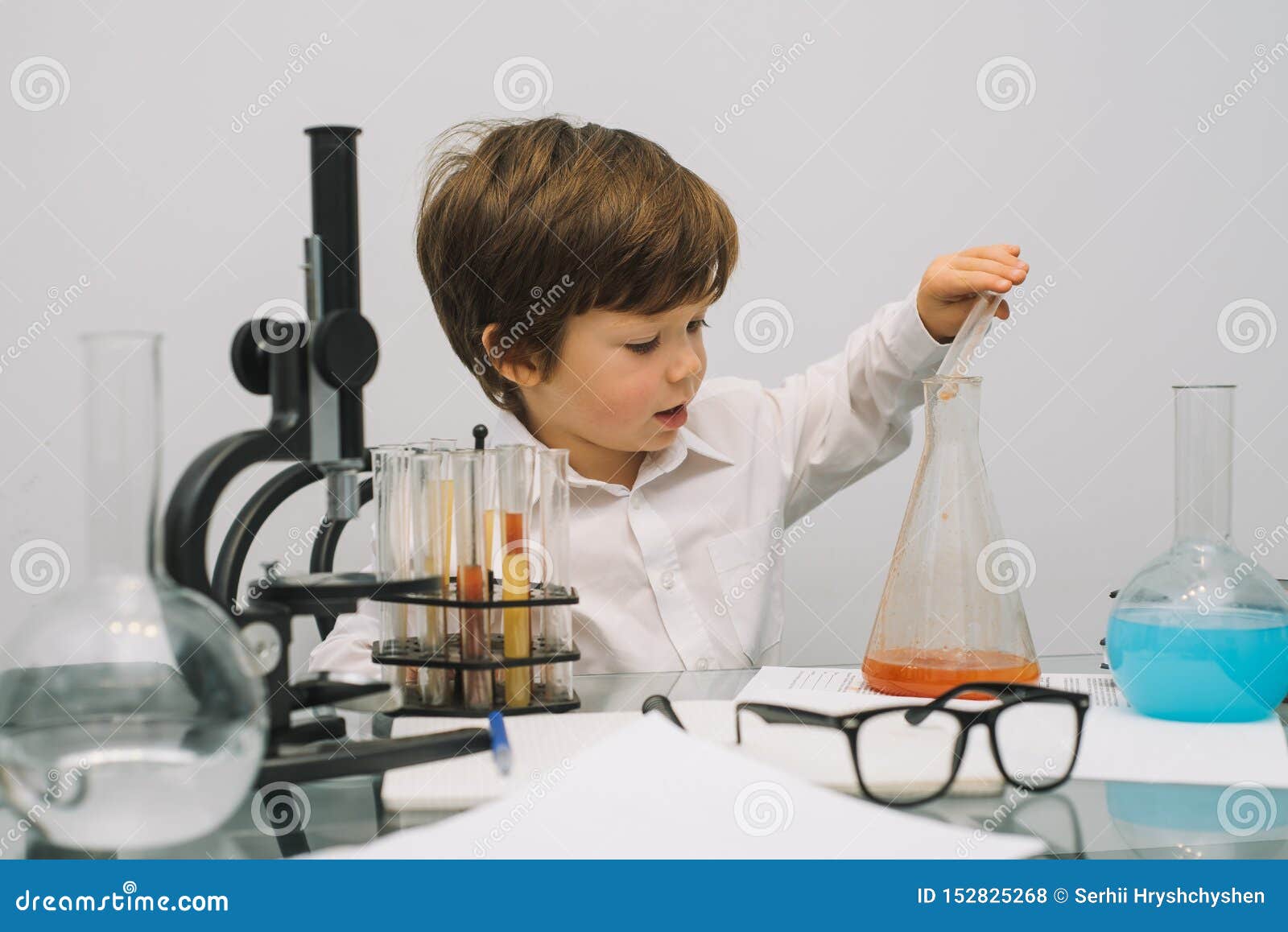 The Boy With A Microscope And Various Colorful Flasks On A White ...