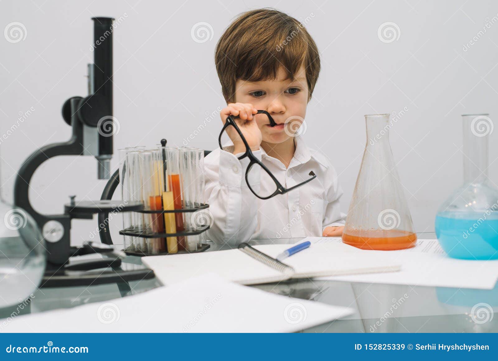 The Boy With A Microscope And Various Colorful Flasks On A White ...