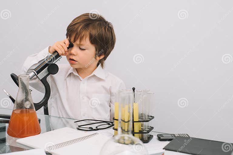 The Boy with a Microscope and Various Colorful Flasks on a White ...