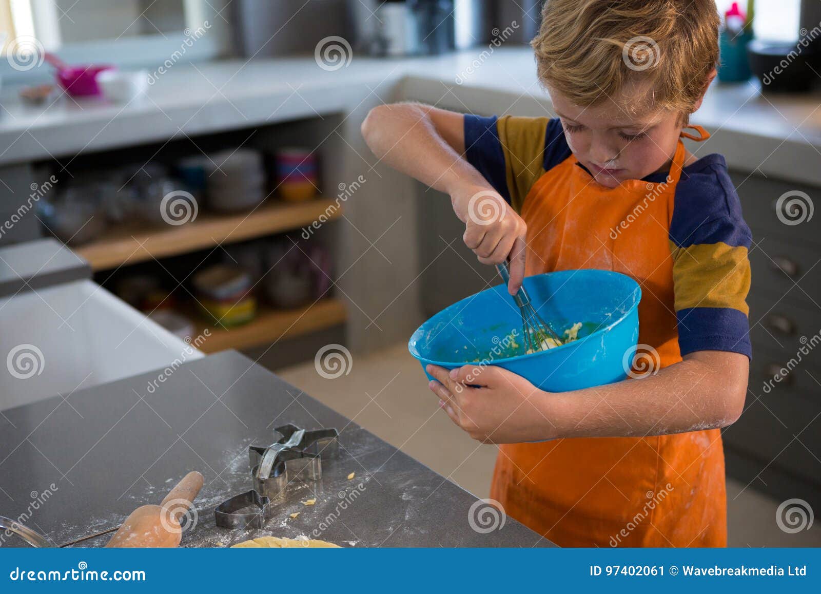 Boy mixing batter in bowl stock image. Image of clothing - 97402061