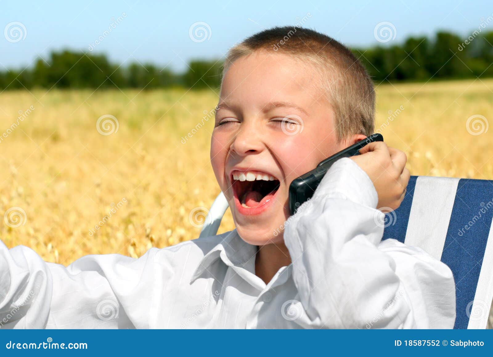 Boy with mobile phone stock photo. Image of laughing - 18587552