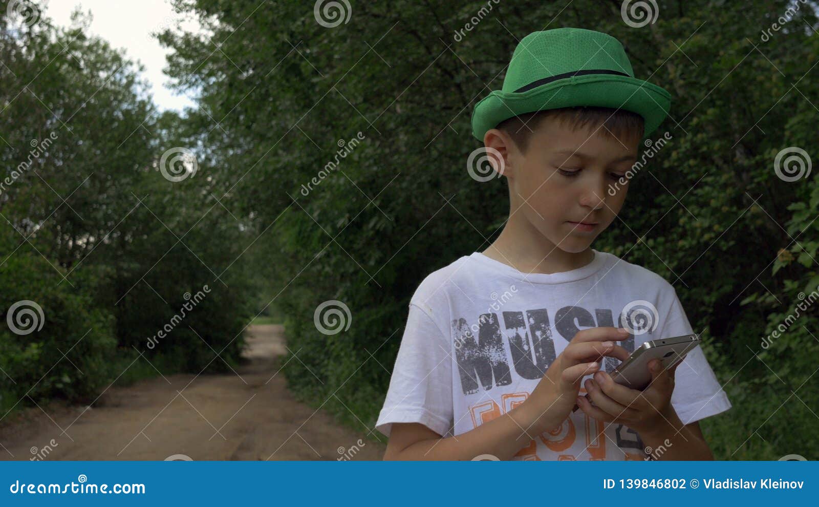 Boy with Mobile Phone Walking Outdoors, Uses Touchscreen Smartphone ...