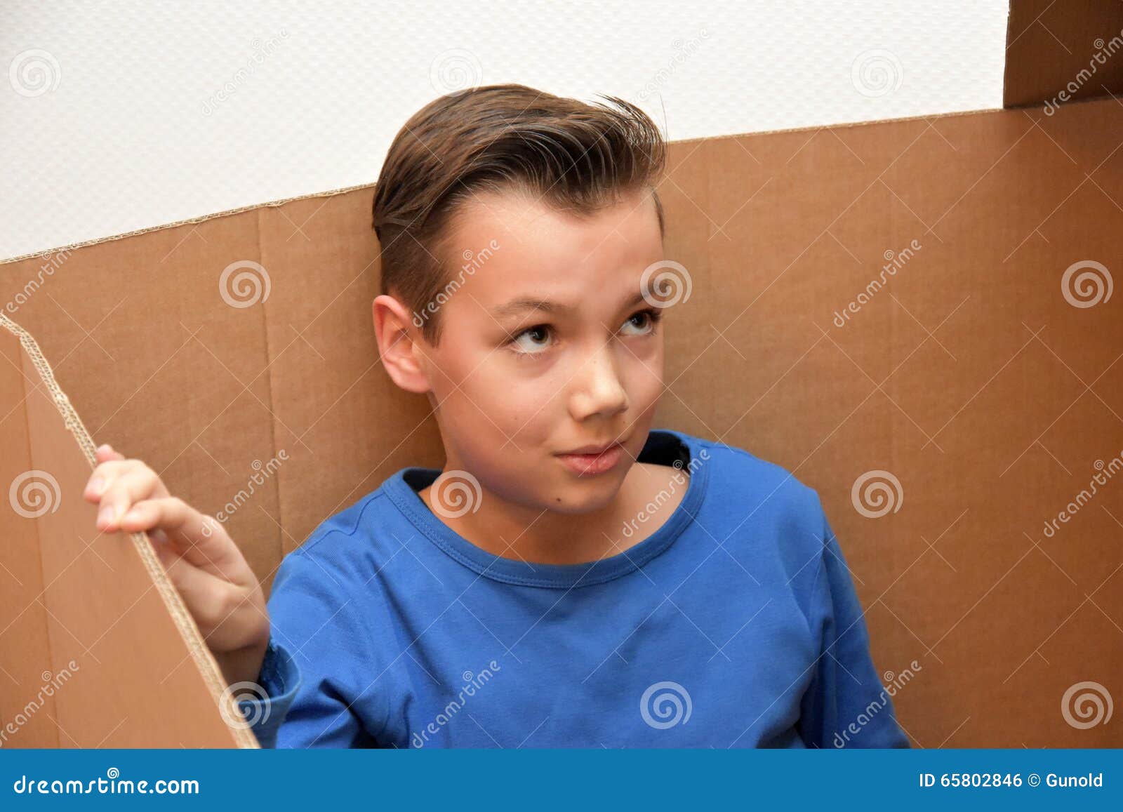Boy in moving box stock photo. Image of teenager, moving - 65802846