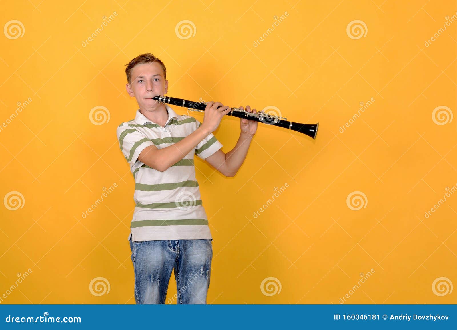 Boy Musician Playing the Clarinet on a Yellow Background Stock Image ...