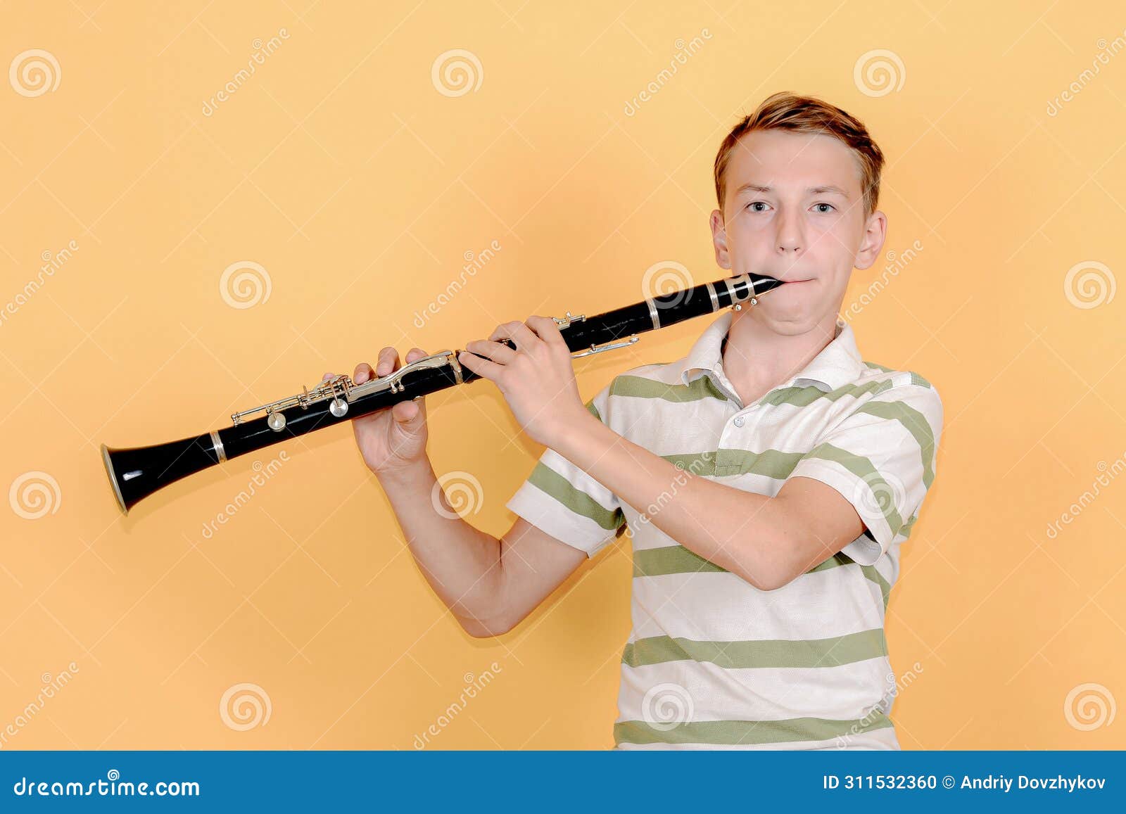 Boy Musician Playing the Clarinet on a Yellow Background Stock Photo ...