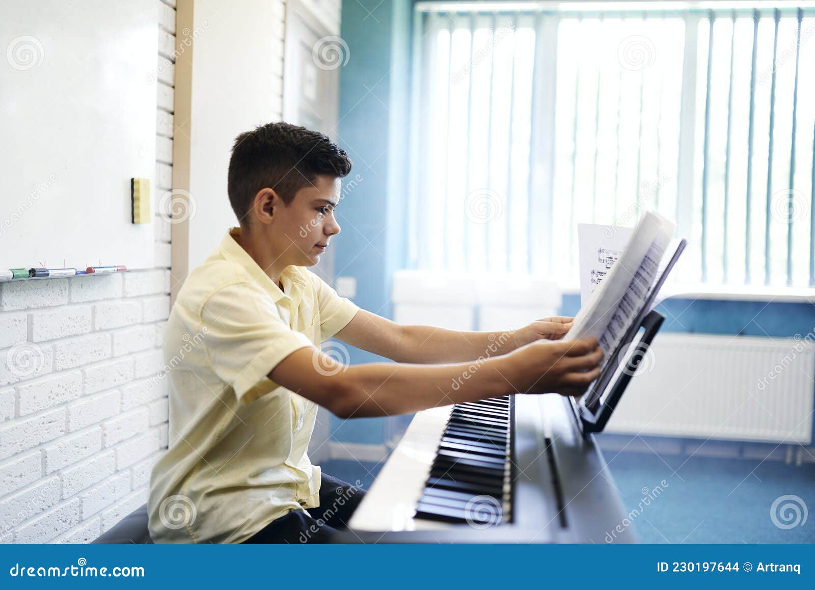 Boy with Note Sheets at Piano Lesson Stock Photo - Image of ...