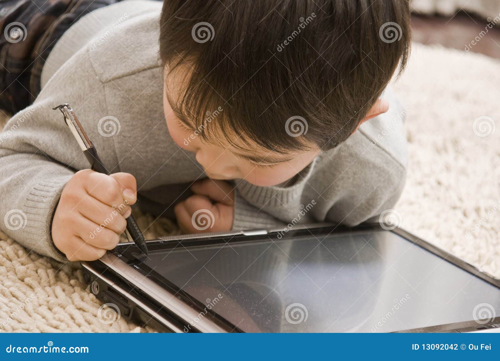 Boy and notebook stock photo. Image of tablet, ground - 13092042