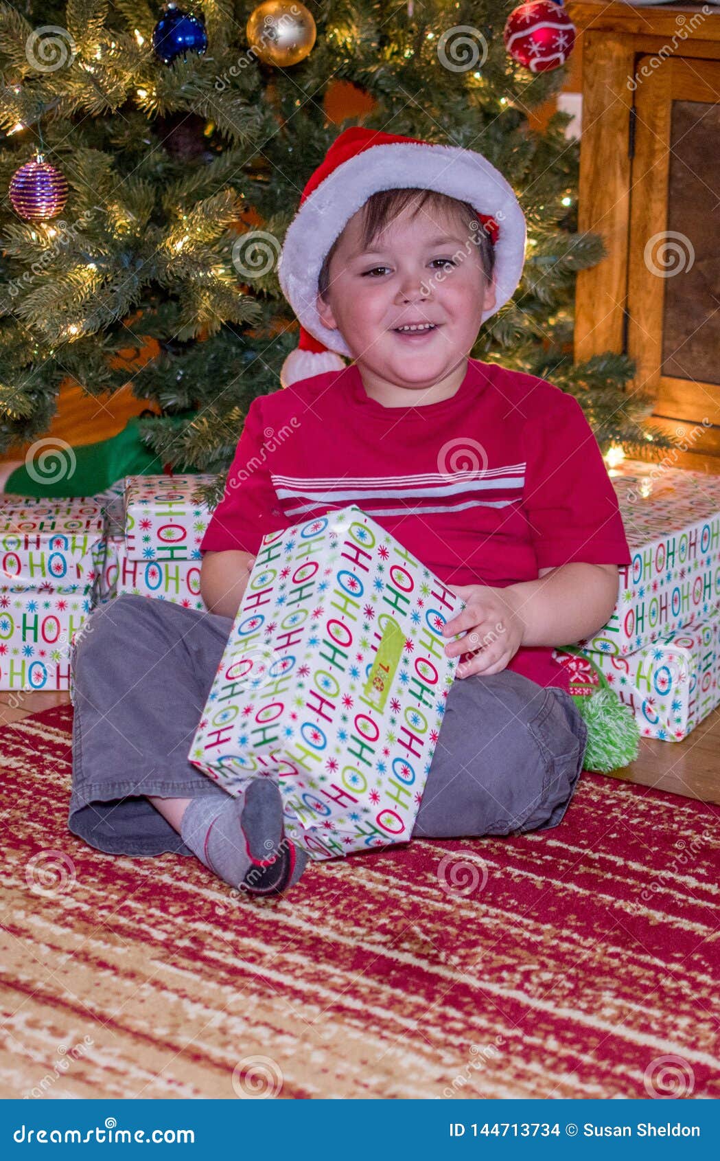 Boy Opening Christmas Presents at Christmas Time Stock Photo - Image of ...