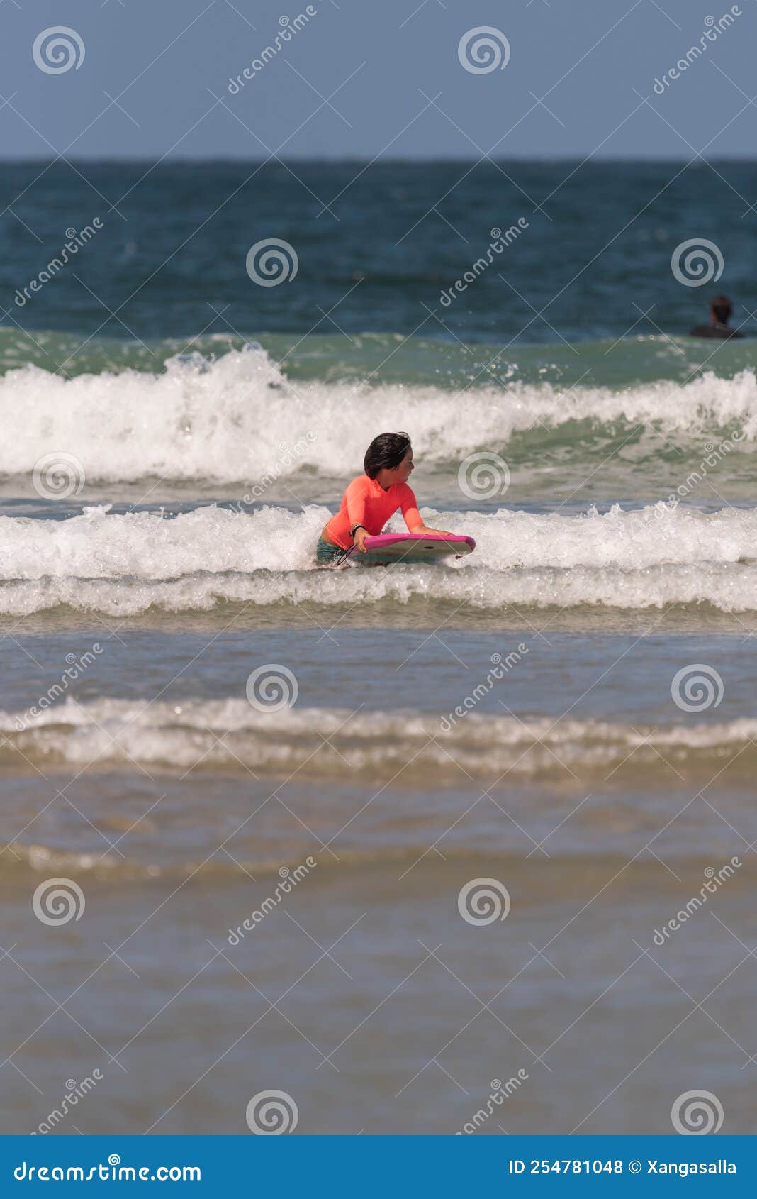 Boy with Orange Equipment and Bodyboard Practices in the Waves of ...