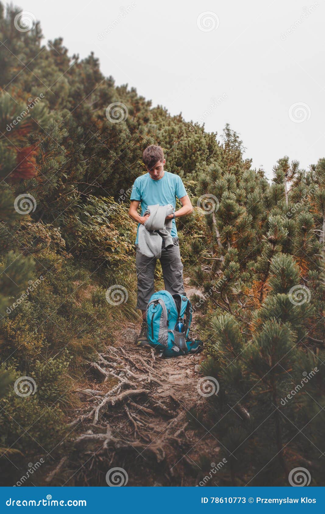 Boy Packing His Clothes To Backpack on Trail Stock Image - Image of ...
