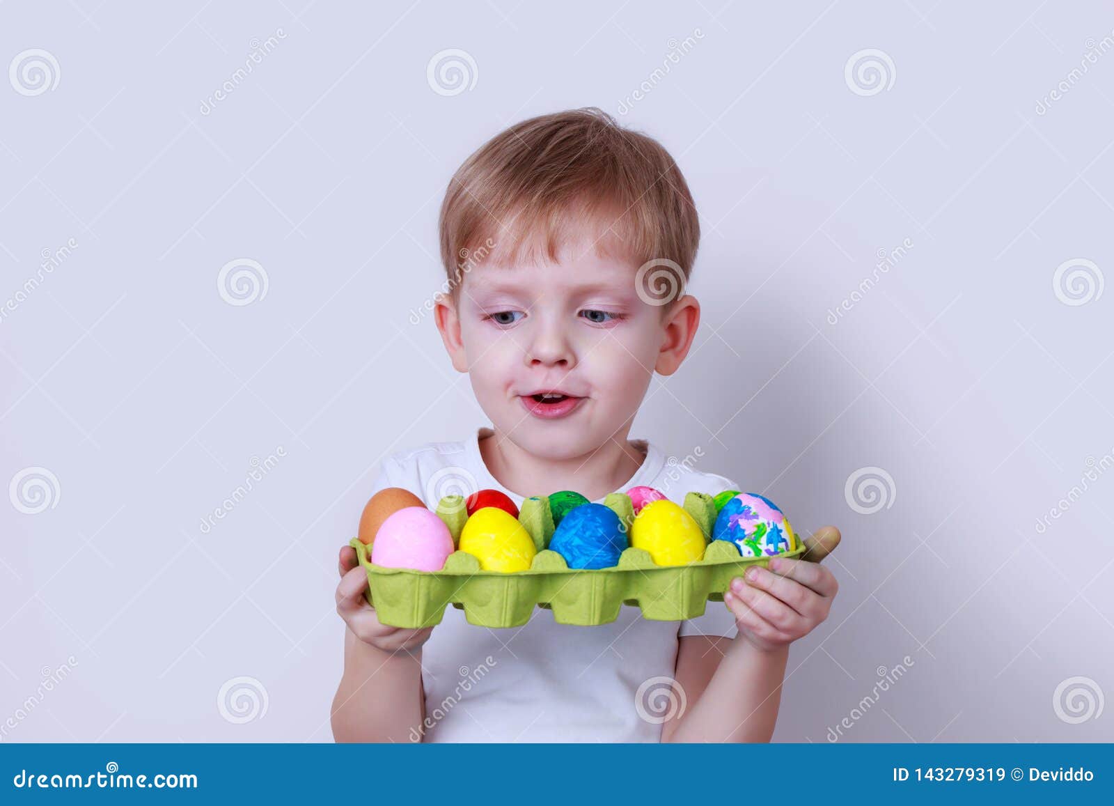 Boy with painted eggs stock image. Image of background - 143279319