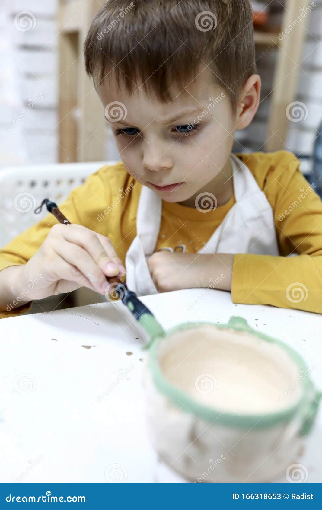 Boy paints clay pot stock image. Image of brush, decoration - 166318653