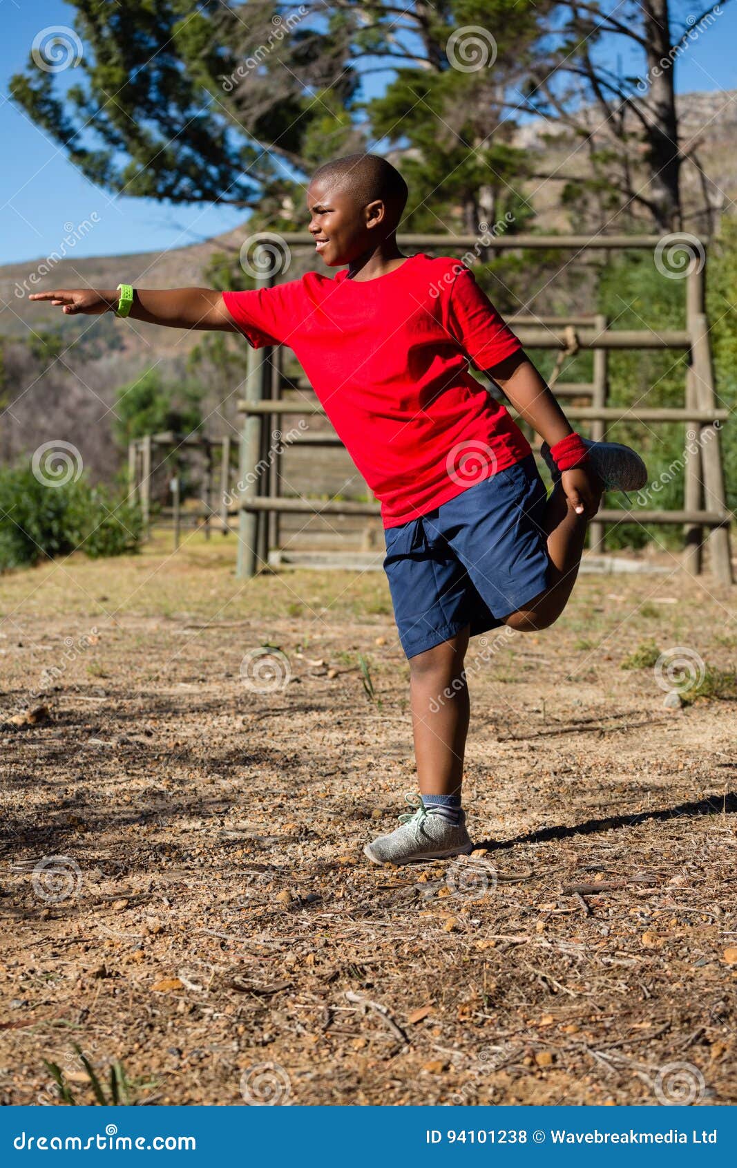 Boy Performing Stretching Exercise during Obstacle Course Training ...