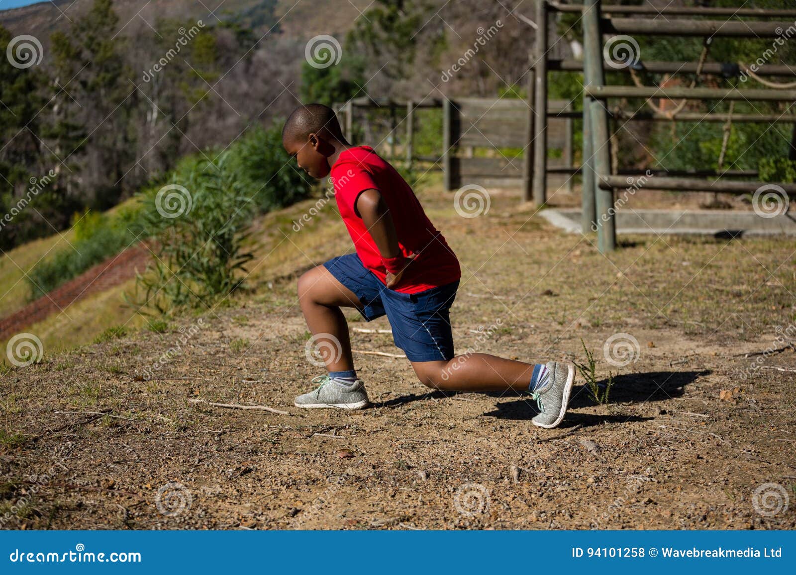 Boy Performing Stretching Exercise during Obstacle Course Training ...