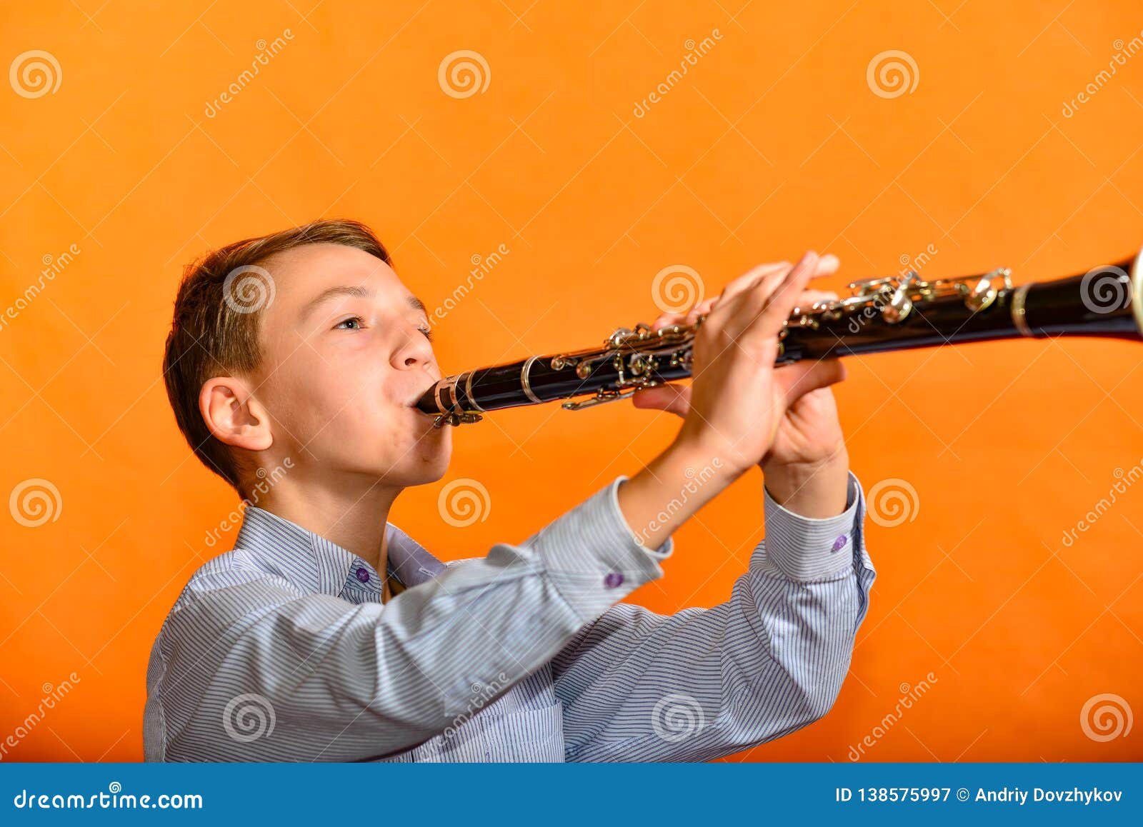 The Boy Performs a Piece of Music in the Music School on the Clarinet ...