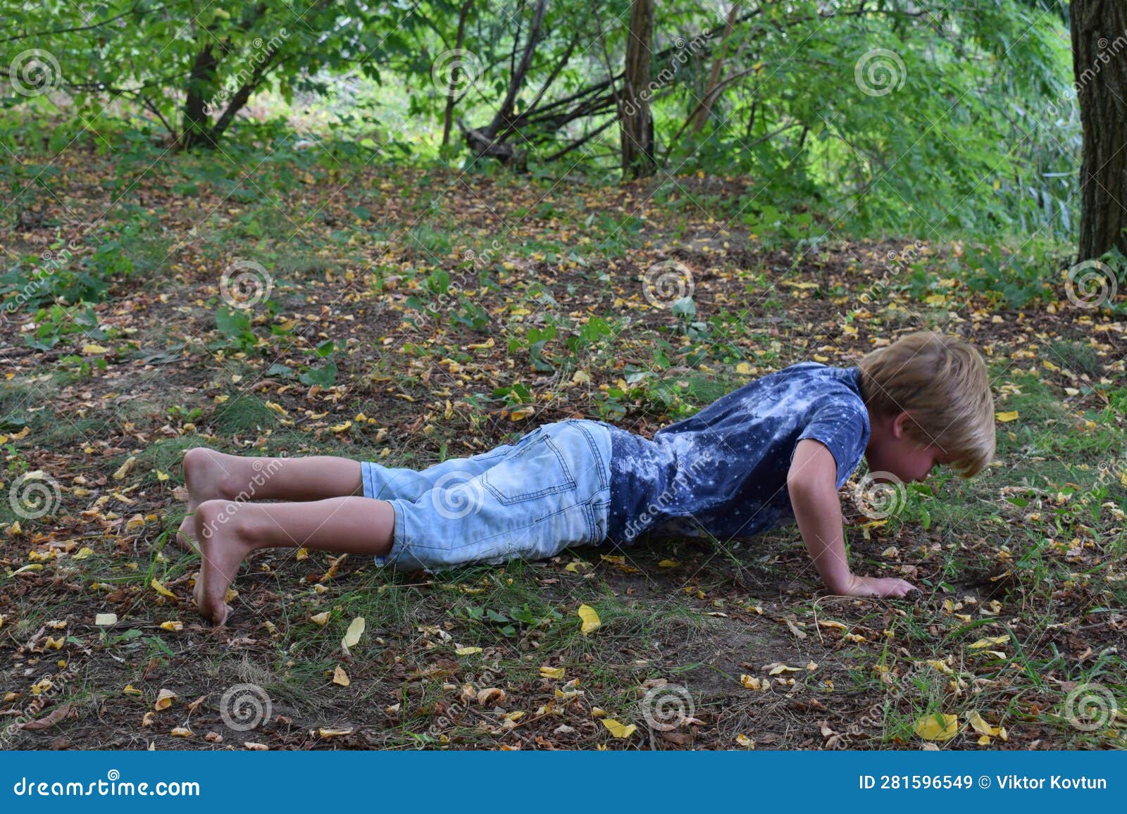 The Boy Performs a Strength Exercise in the Forest Stock Image - Image ...