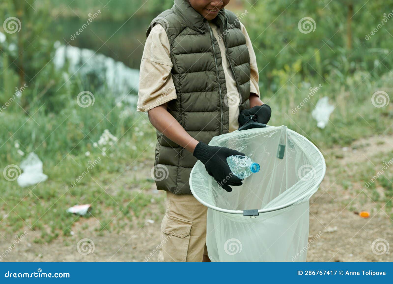 Boy Picking Up Garbage in Bag Outdoors Stock Image - Image of plastic ...