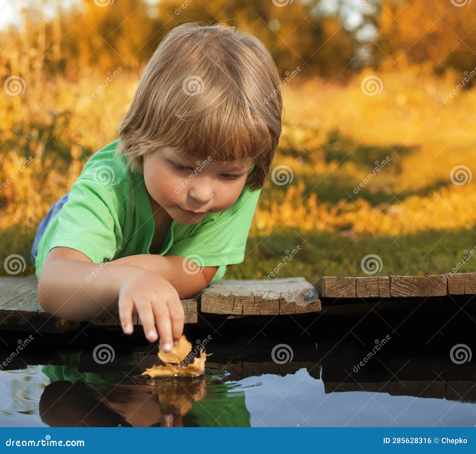 Boy Play with Autumn Leaf Ship in Water Stock Photo - Image of color ...