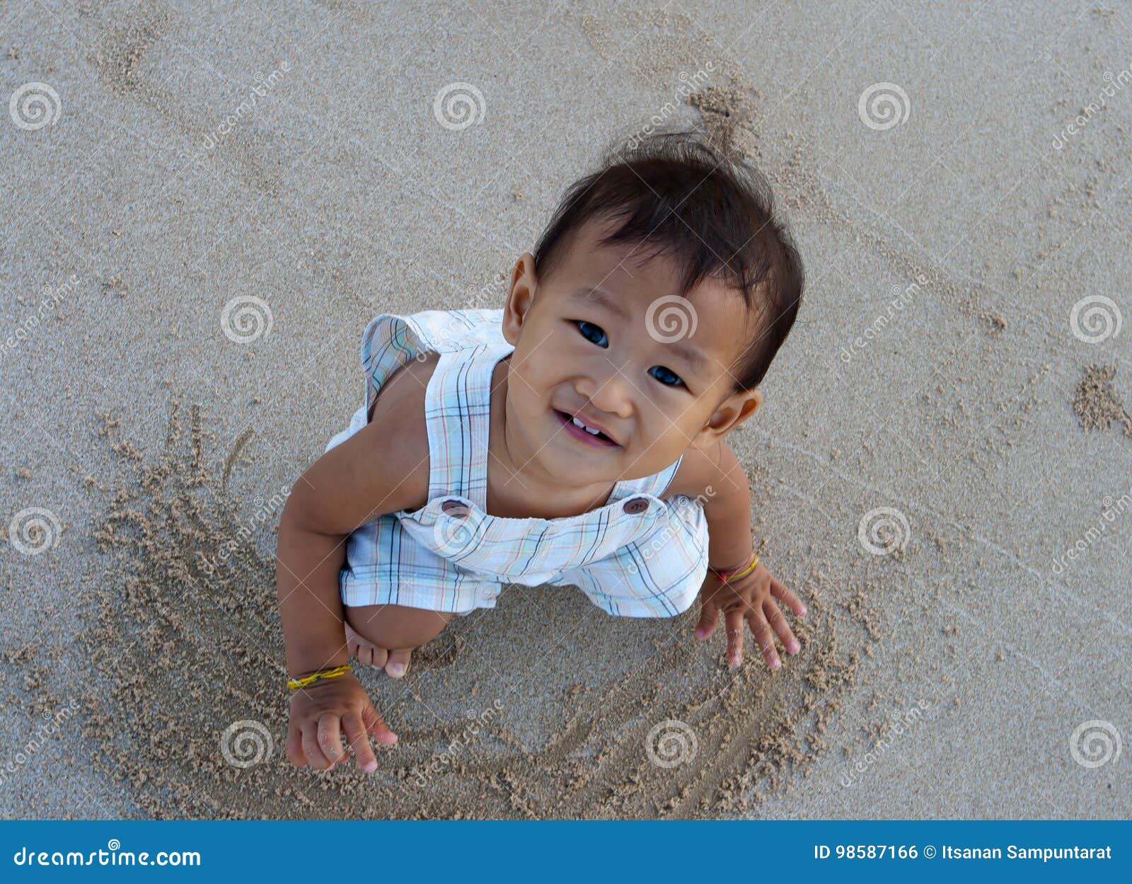 Boy play sand on the beach stock photo. Image of cute - 98587166