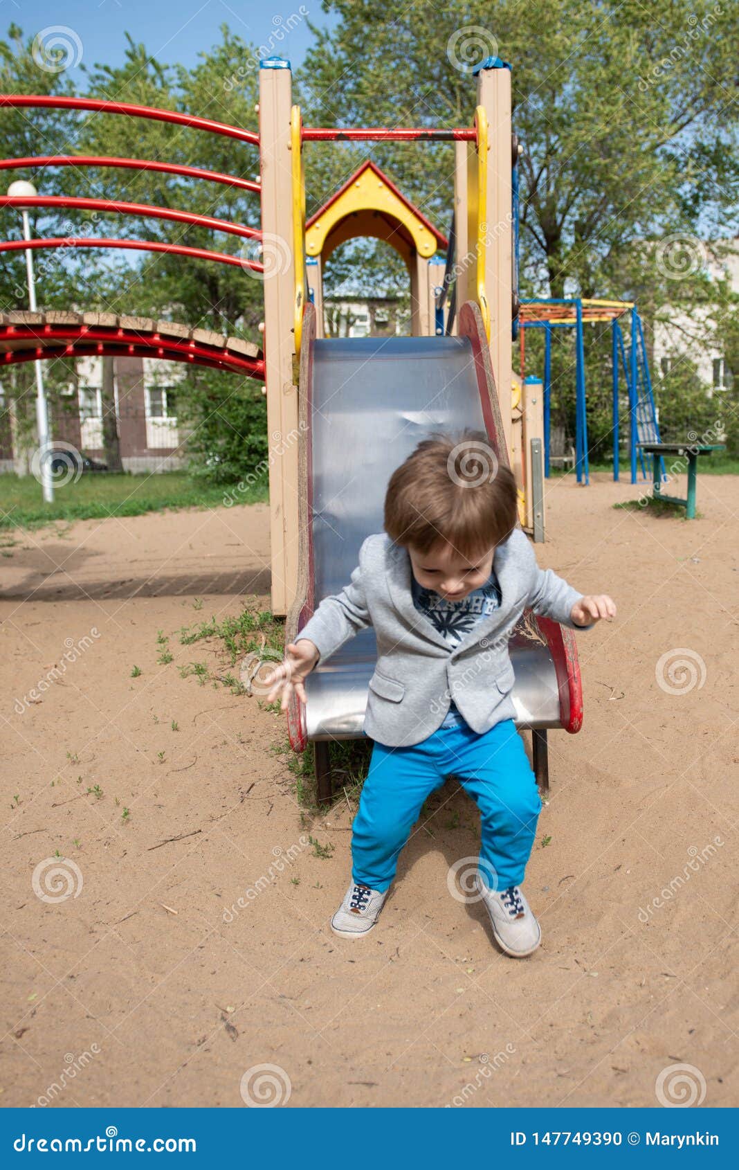 Boy on the Playground Rolls Down a Hill Stock Photo - Image of kindly ...