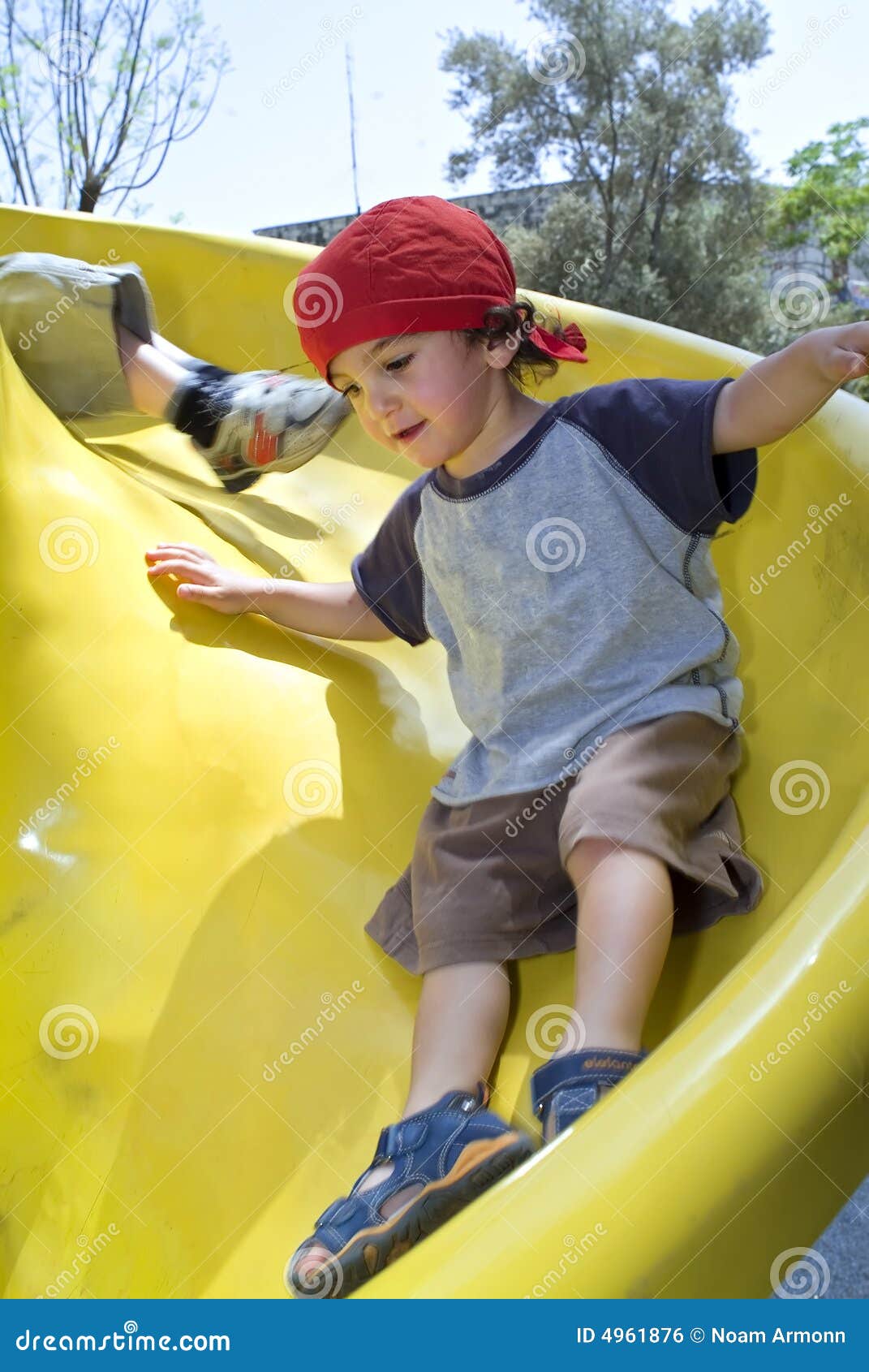 Boy on a playground slide stock photo. Image of cheerful - 4961876