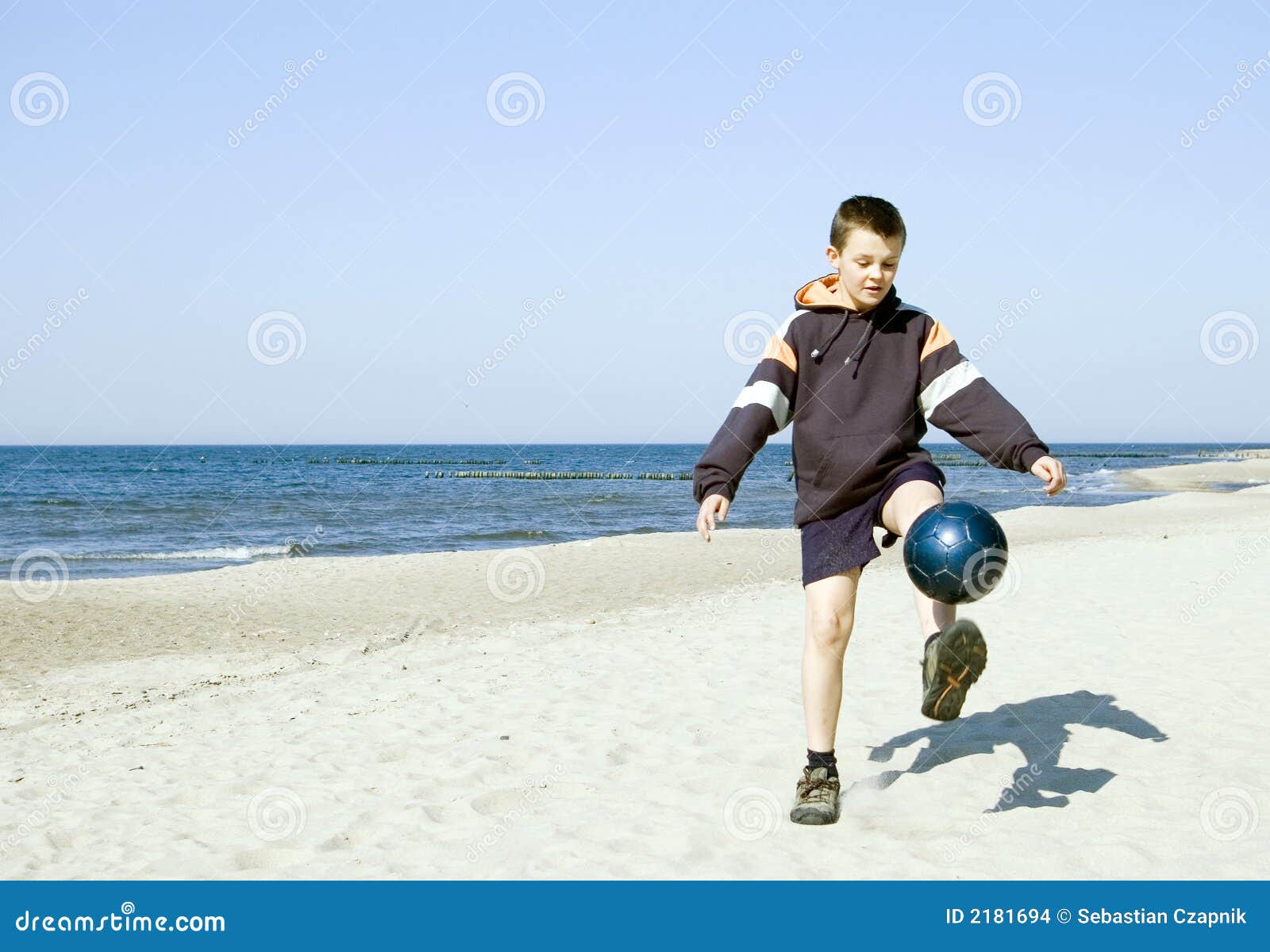 Boy playing ball on beach. stock photo. Image of blue - 2181694