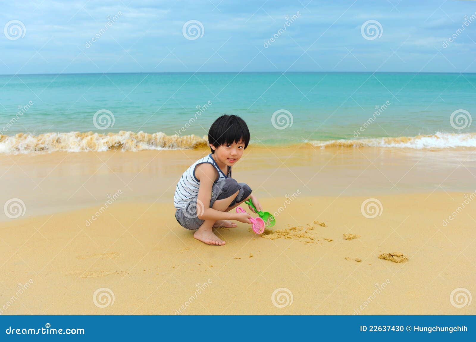 Boy playing on the beach stock photo. Image of clear - 22637430