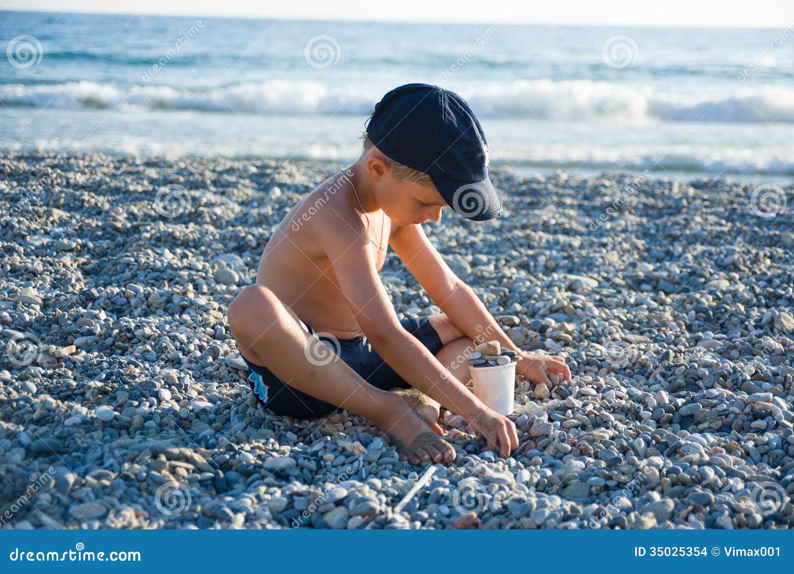 Boy playing at the beach stock photo. Image of person - 35025354