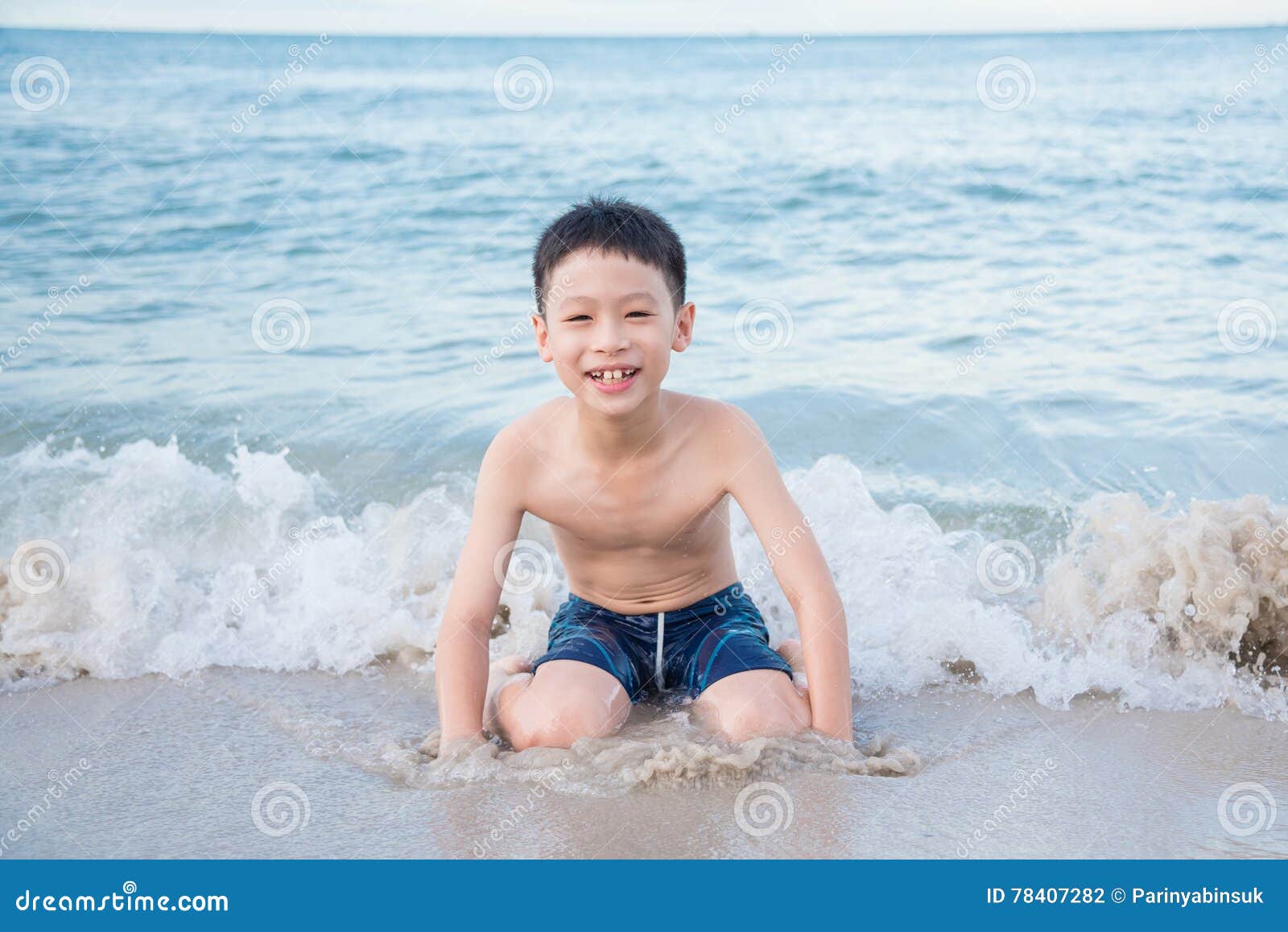 Boy playing on the beach stock photo. Image of relax - 78407282